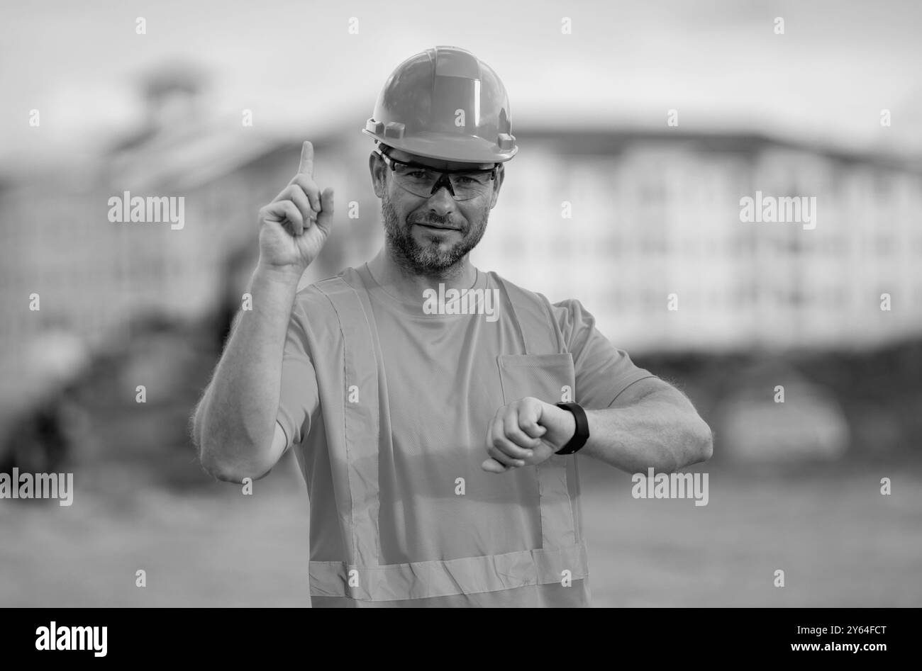 Worker in building uniform on buildings construction background ...