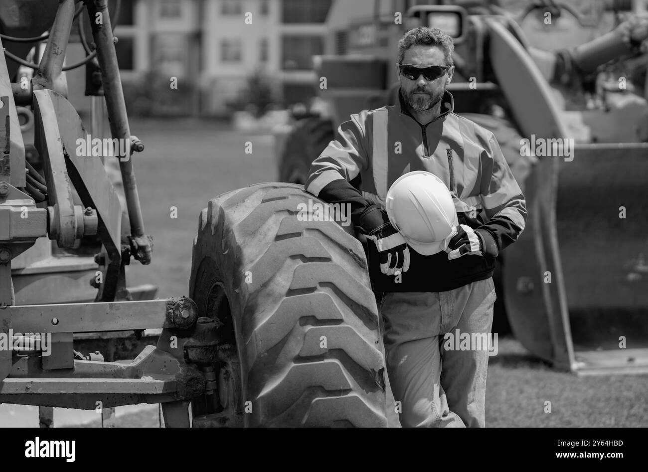 Machinery builder at buildings background. Excavator loader tractor and ...