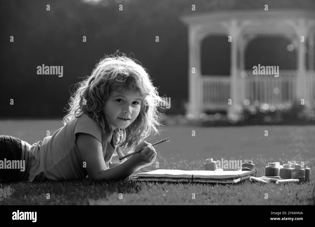 Children draw paint pictures outside, childrens creativity. Child boy ...