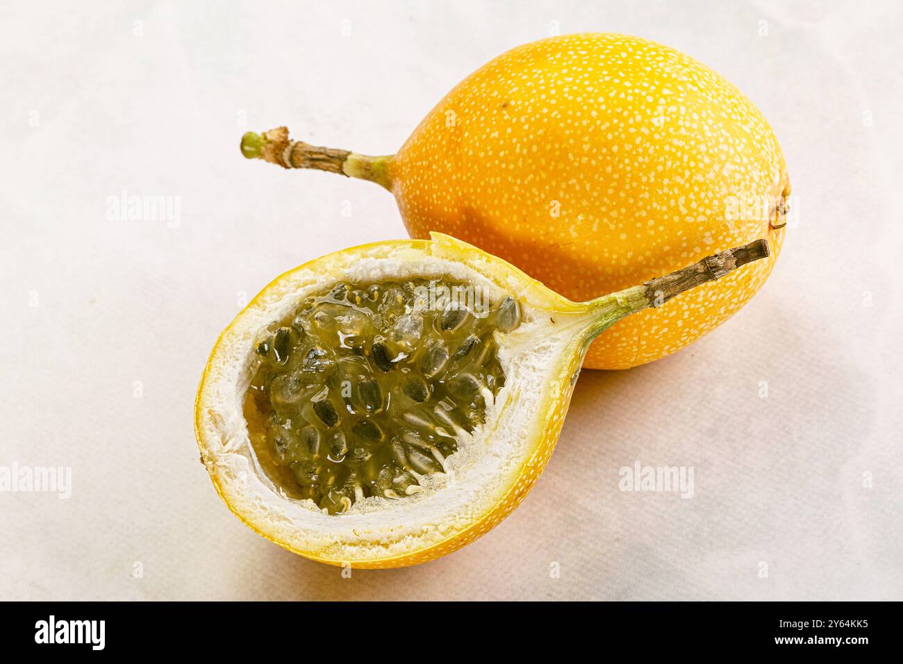 Yellow granadilla fruit with cut half Stock Photo - Alamy