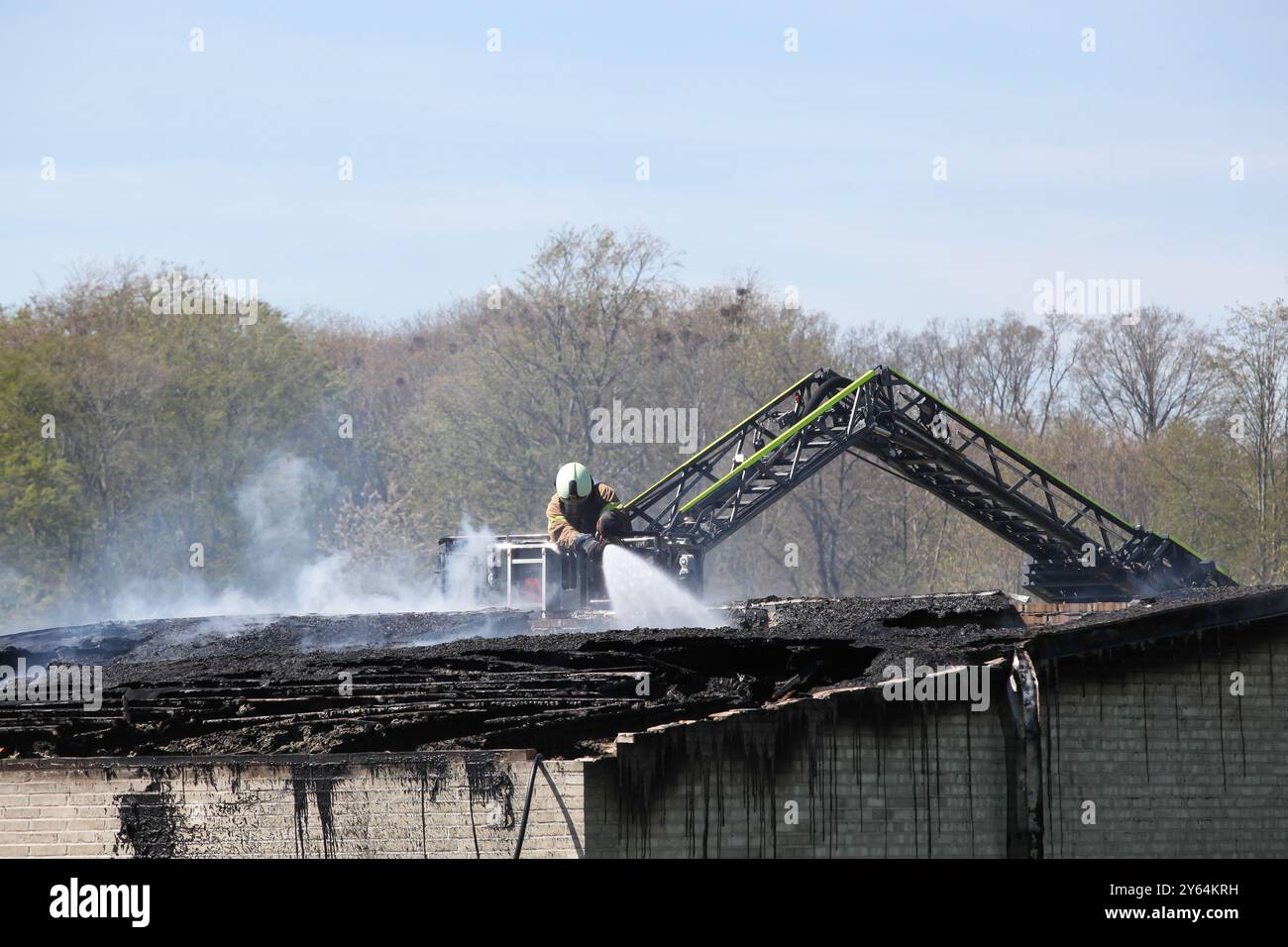 Firefighter putting out a fire in a house in Denmark Stock Photo - Alamy