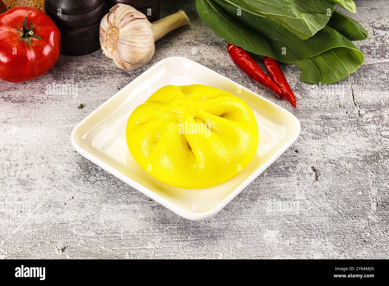 Asian stuffed steamed yellow Bun Bao Stock Photo - Alamy