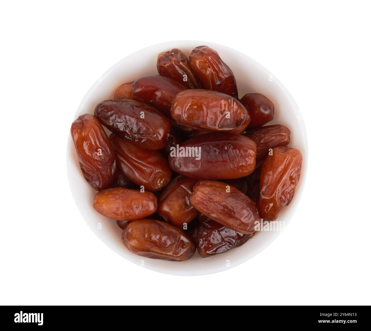 Dates in bowl isolated on a white background Stock Photo - Alamy