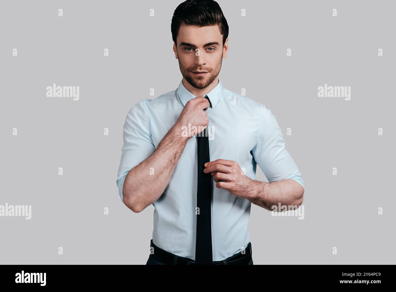 Used to look perfect. Good looking young man in formalwear looking at ...