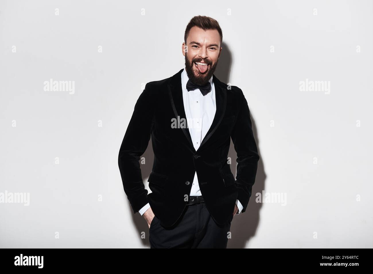 No rules. Playful young man in full suit sticking out tongue and ...