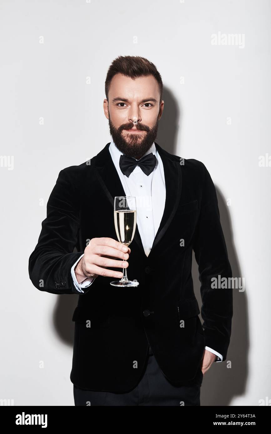 Cheers! Handsome young man in full suit toasting you and smiling while ...
