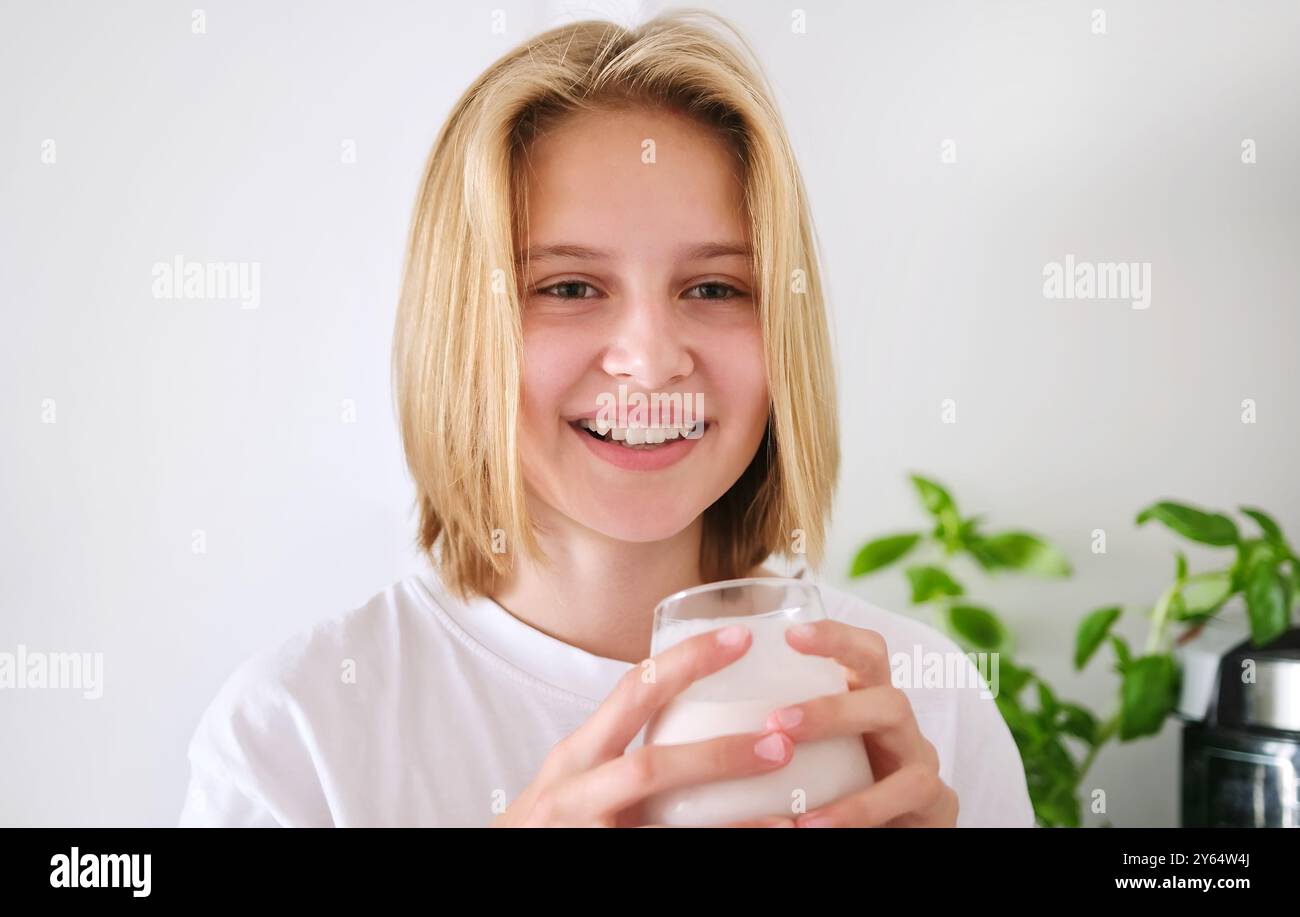 Cute Little Girl Drinking A Raspberry Milkshake From A Glass While ...