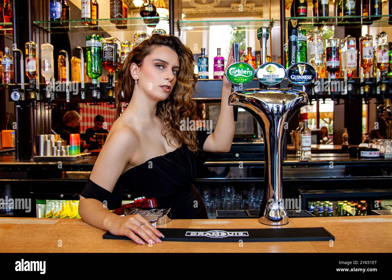 Al female model, poses for a photograph behind the bar inside the ...