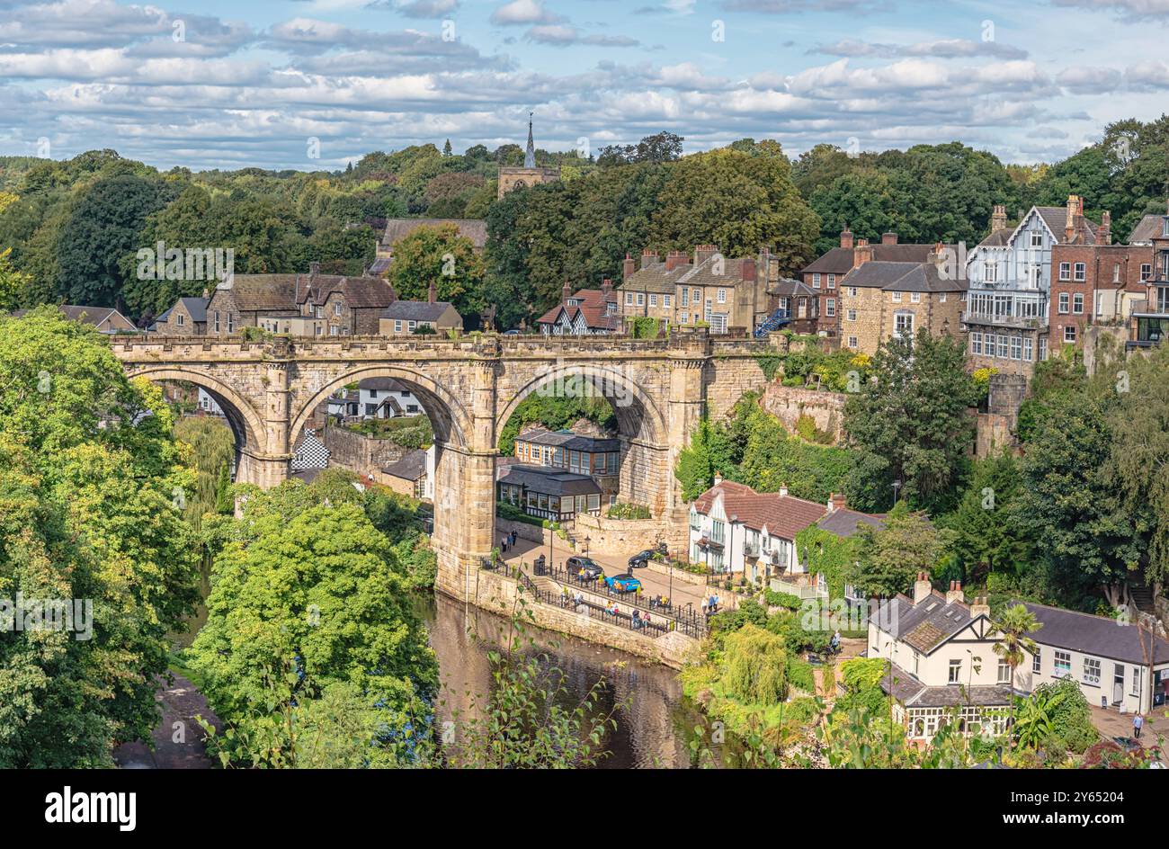 A 19th Century built viaduct crosses a deep valley surrounded by ...