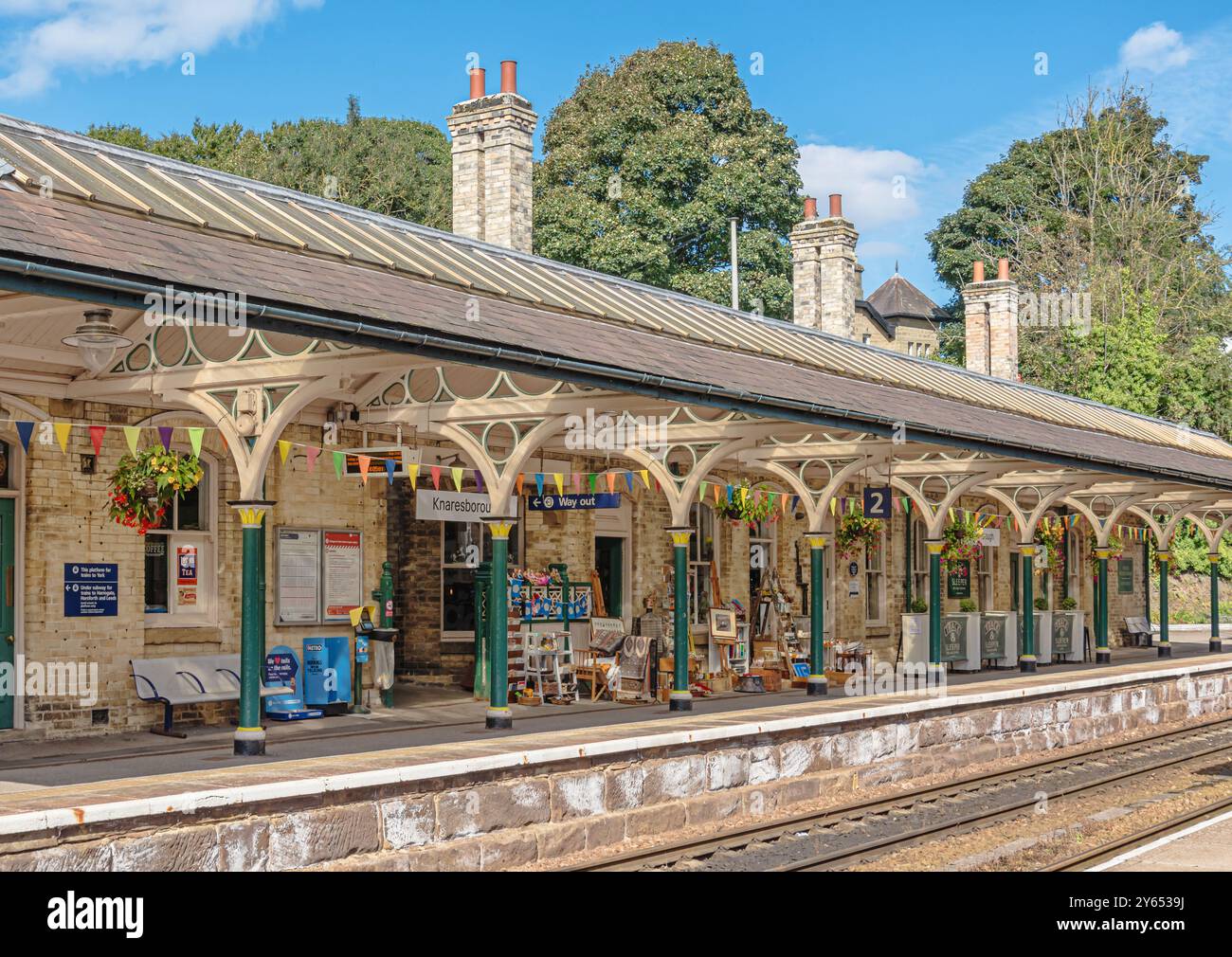 A quaint 19th Century railway station platform. Columns hold up the ...