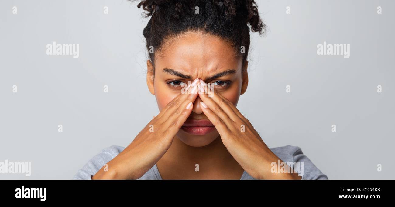 Exhausted black girl suffering from antritis, rubbing nose bridge Stock ...