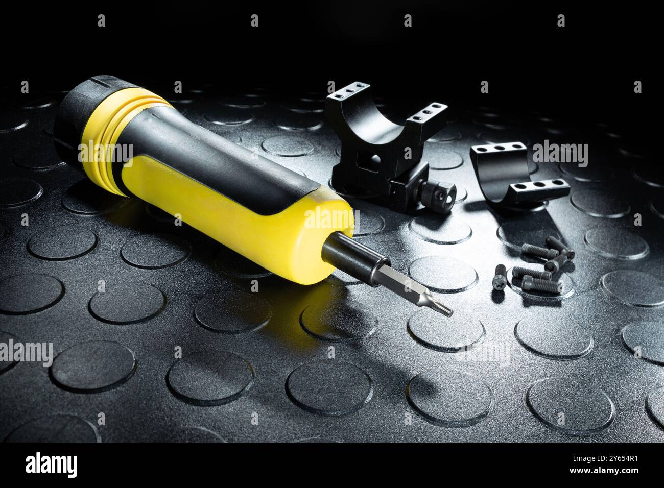 Yellow and black torque driver that measures in inch pounds next to ...