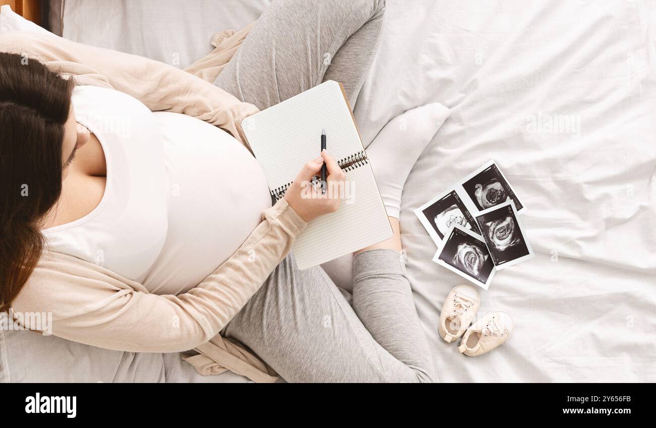 Pregnant woman making packing list for maternity hospital Stock Photo ...