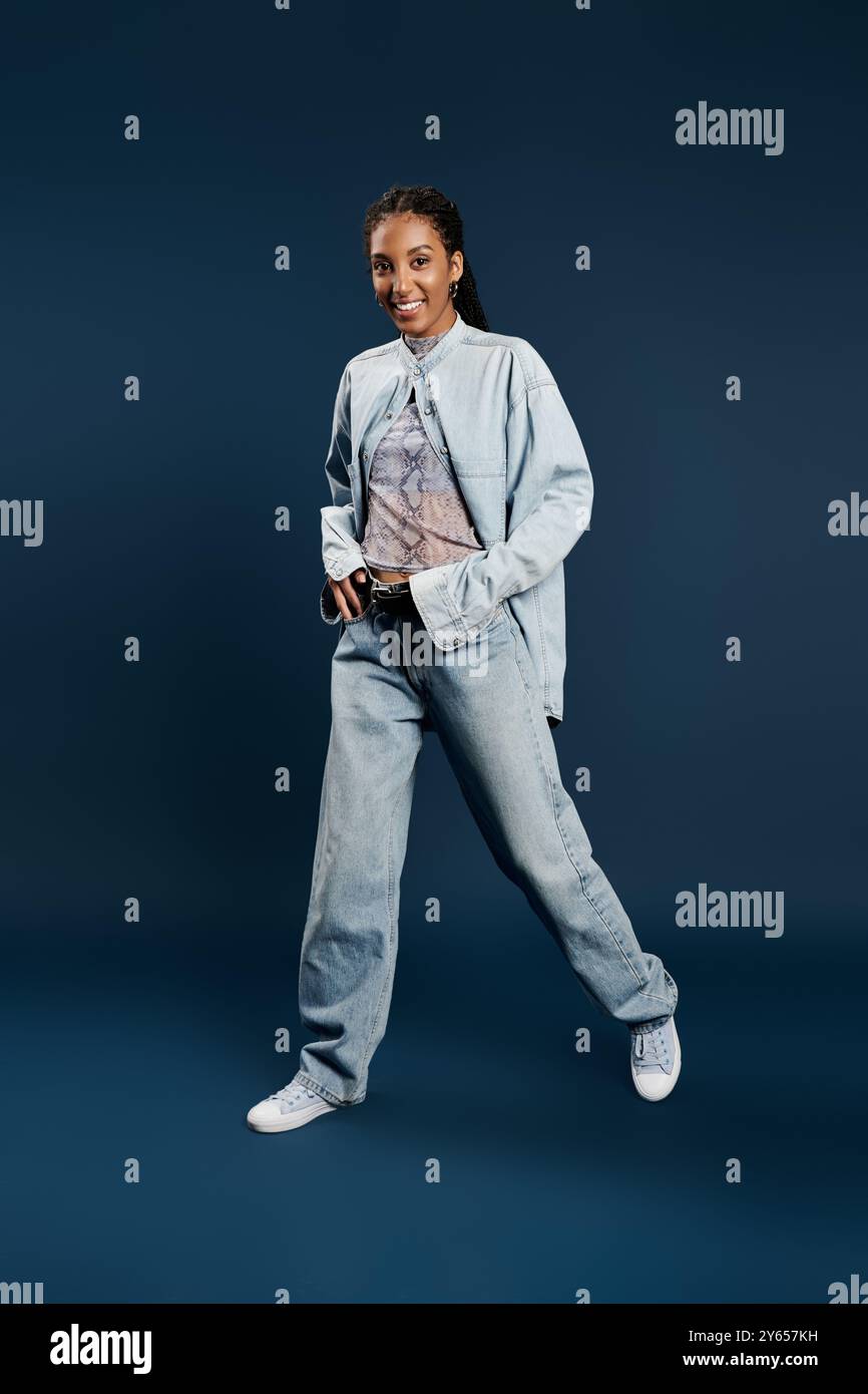 A confident young woman models an eye catching outfit against a bold ...