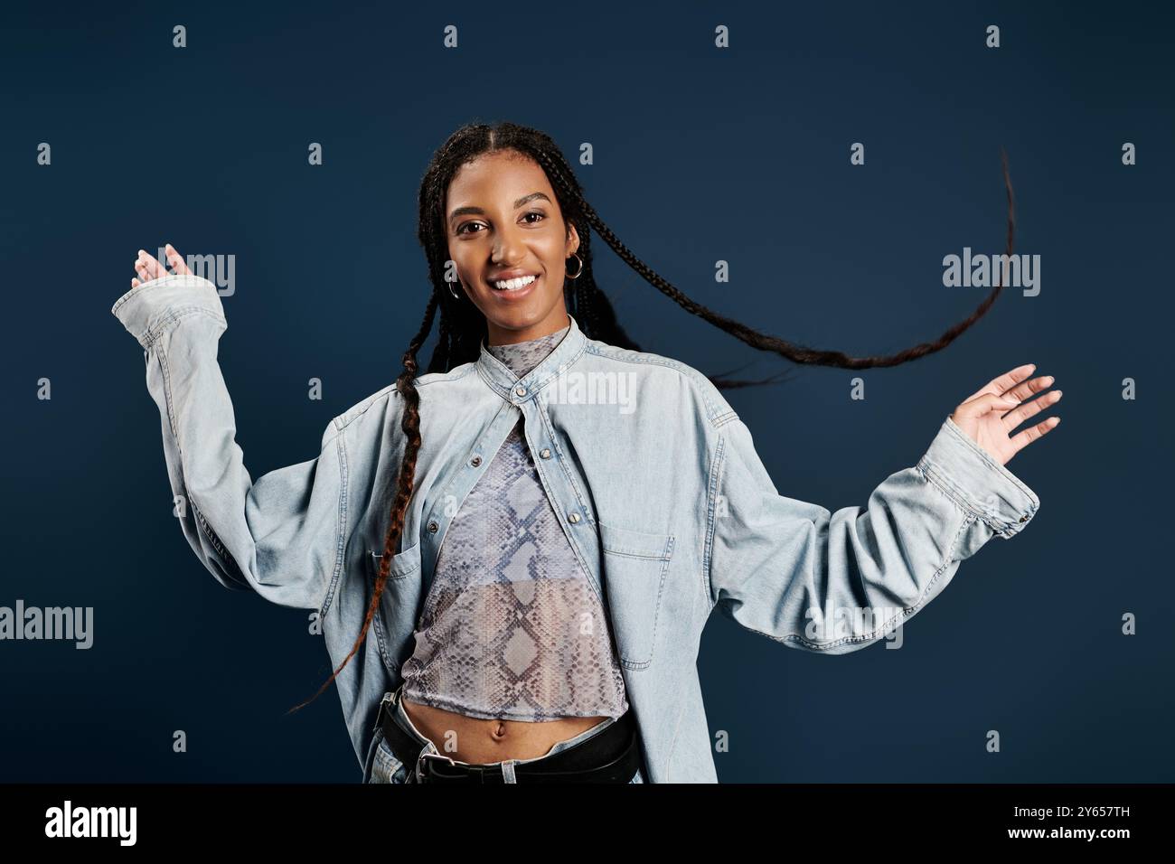 Styled in contemporary fashion, a young woman exudes joy and confidence ...