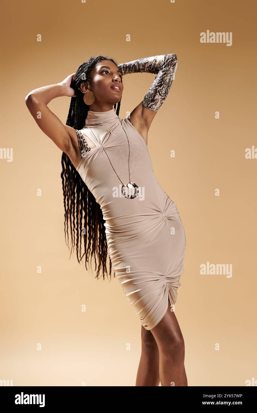 A beautiful young woman poses gracefully, flaunting her fashionable ...
