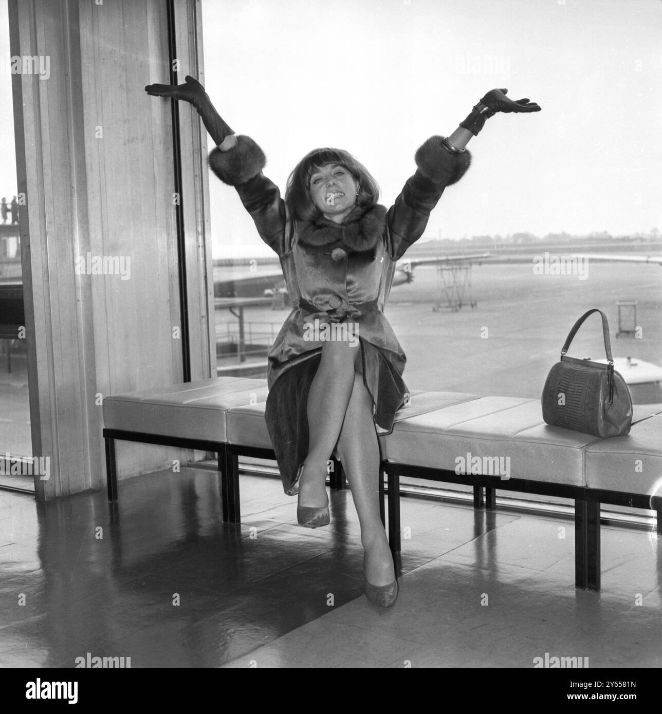 Signalling a big hello at London Airport is Gillian Lynne , British ...