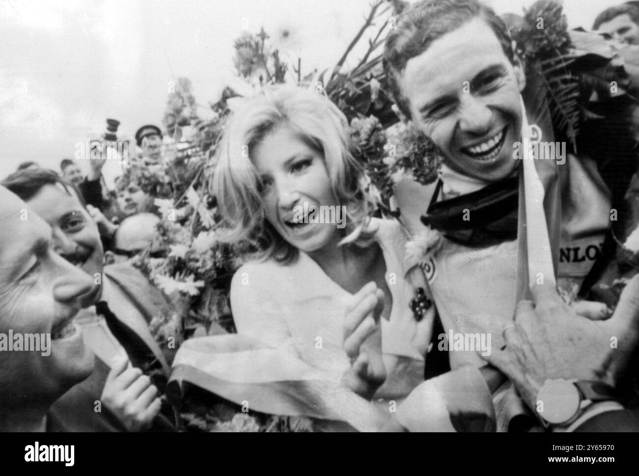 Britain's Jim Clark receives his victor's laurels from beautiful ...