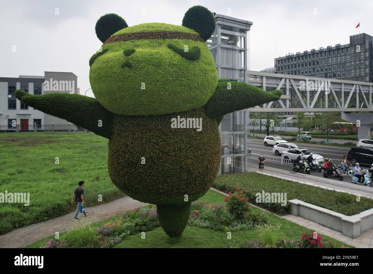 A view of a ten-meter-tall hedge sculpture depicting a panda balancing ...