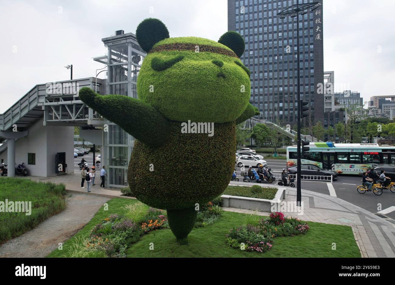 A view of a ten-meter-tall hedge sculpture depicting a panda balancing ...