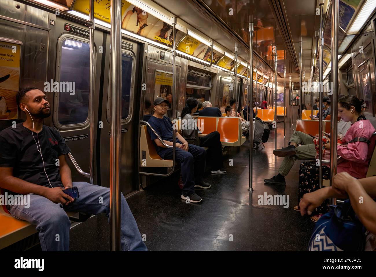 People ride Subway train in New York. With 1.67 billion annual rides ...