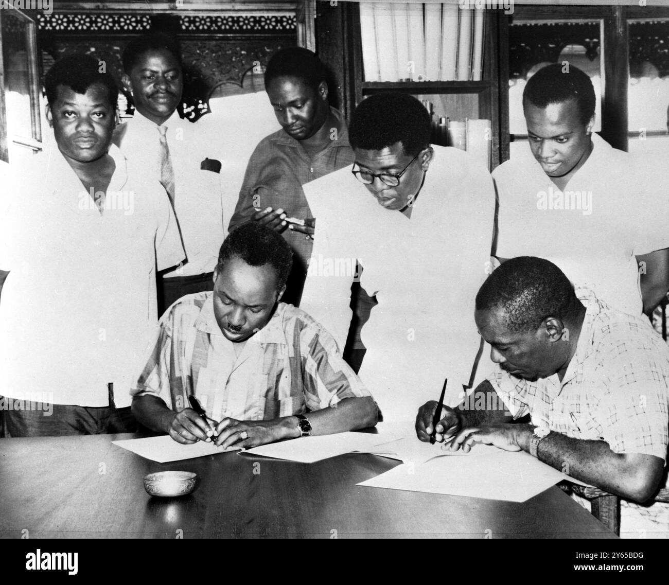 Zanzibar : From left near camera , Tanganyika ' s Kambona and President ...