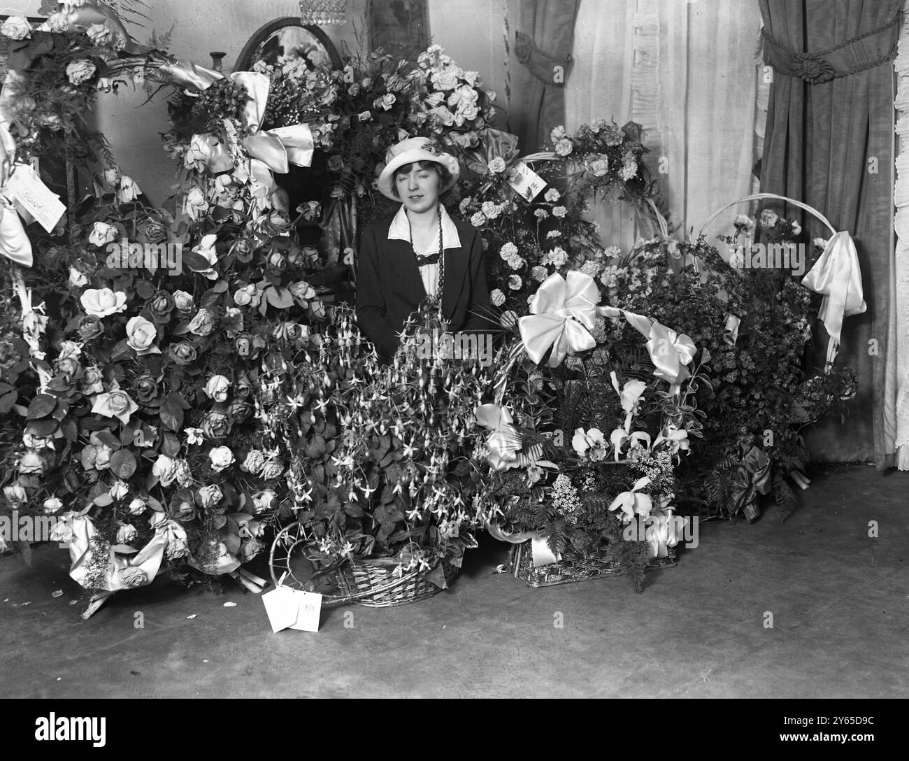 The famous actress , Miss Ina Claire pictured with her flowers which ...