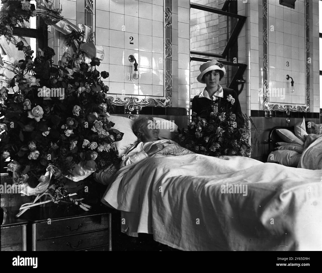 Miss Ina Claire , the actress , takes flowers to patients at the ...