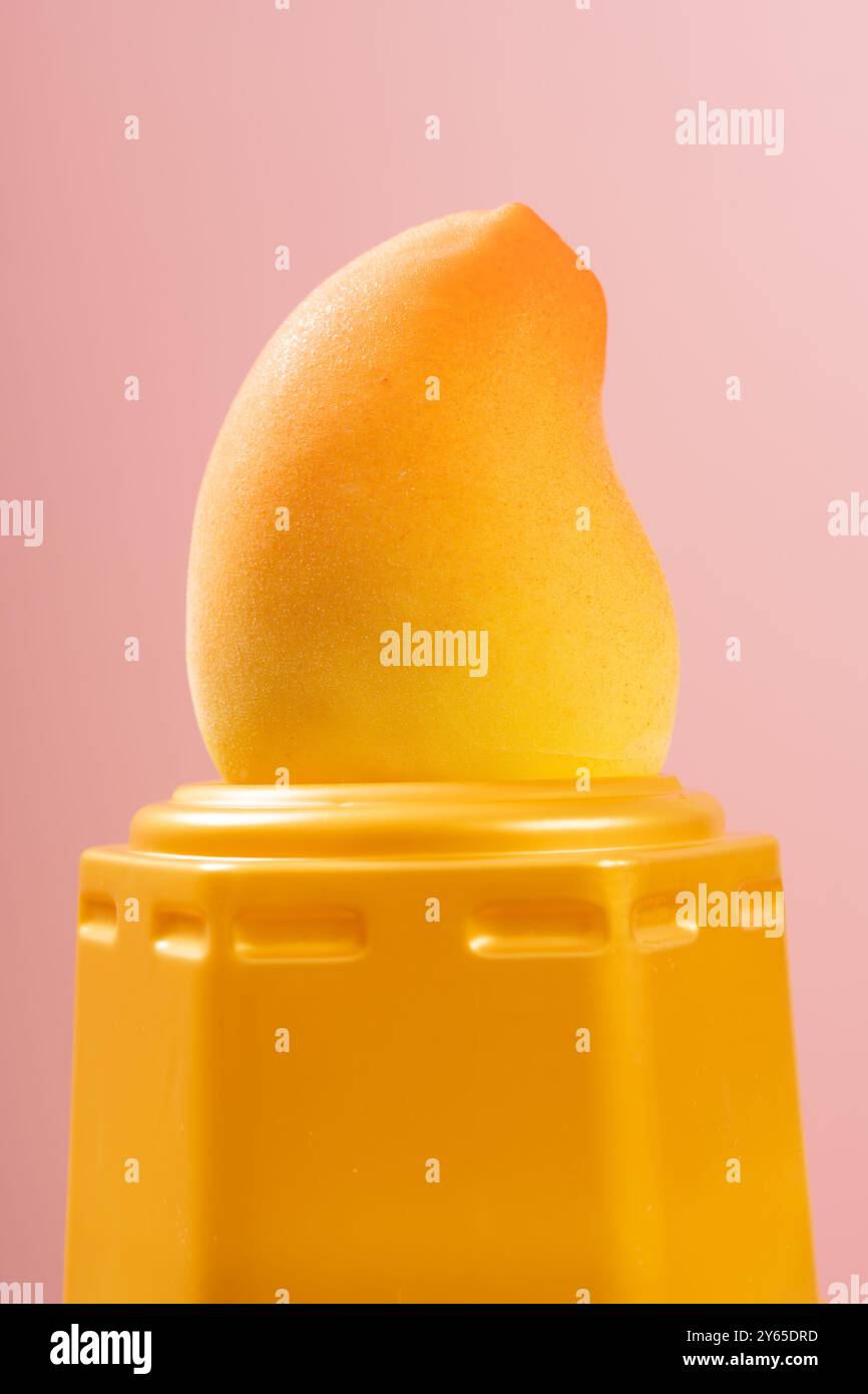 beauty mango shape and mango flavor popsicle melting on pink background ...