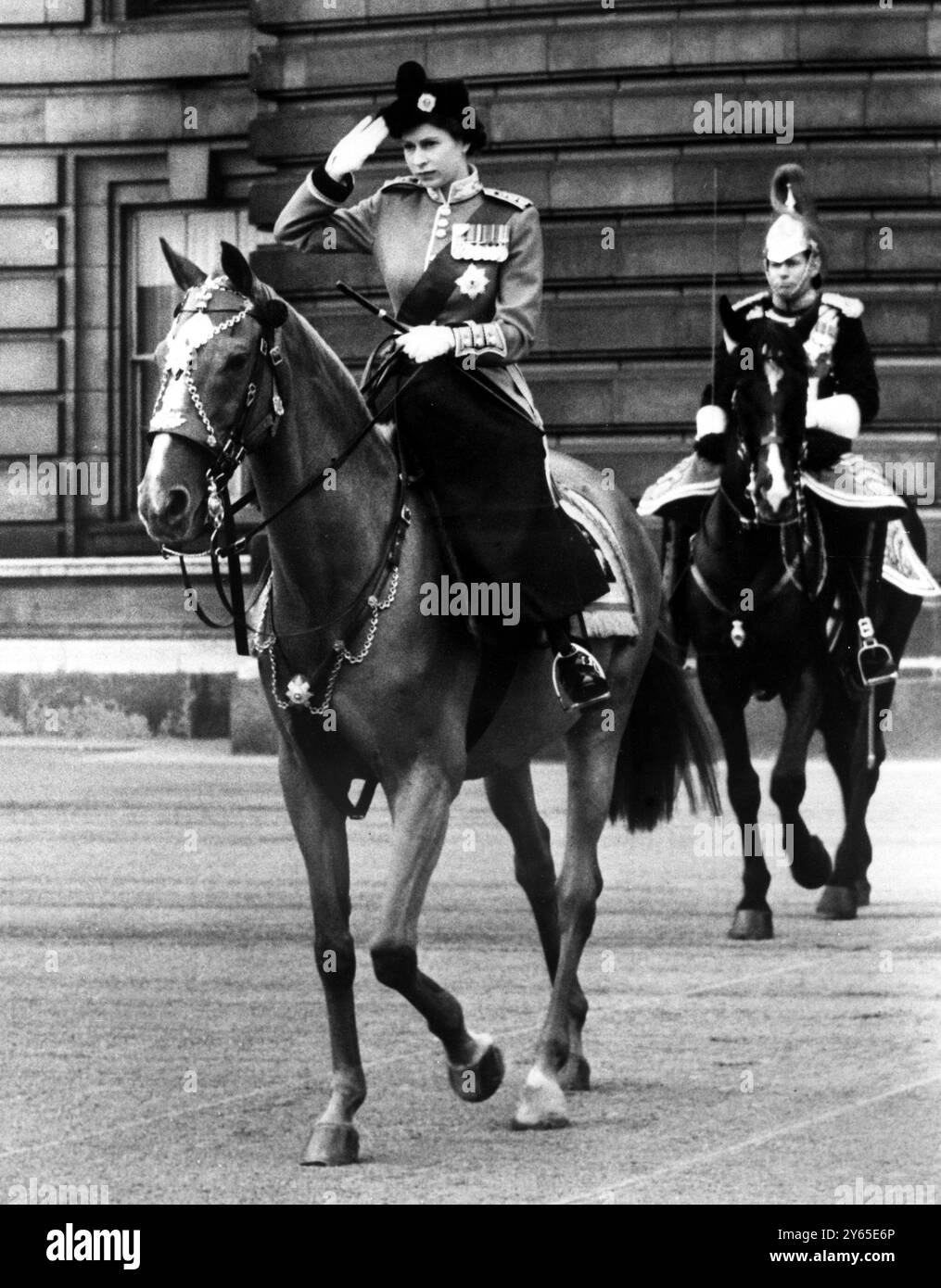 For the first time as Sovereign The Queen riding 'Winston' salutes as ...