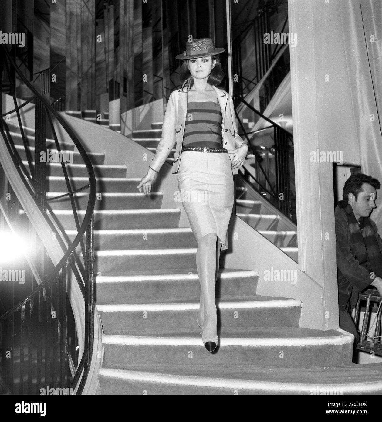 Paris: A beige twill suit worn with a blouse with trap top in blue and ...