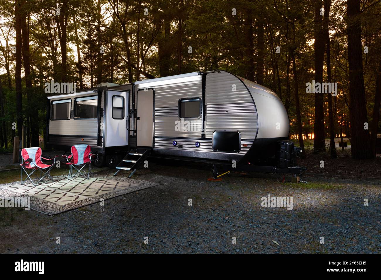 Sun low on the horizon with an RV campsite that is the definition of ...