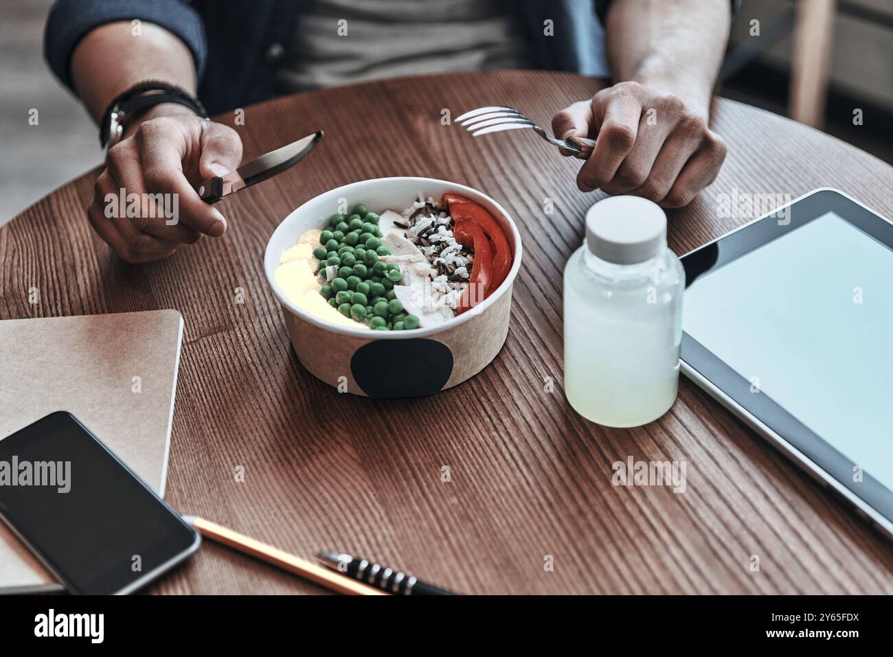 Good healthy dinner. Close-up top view of man holding fork and table ...
