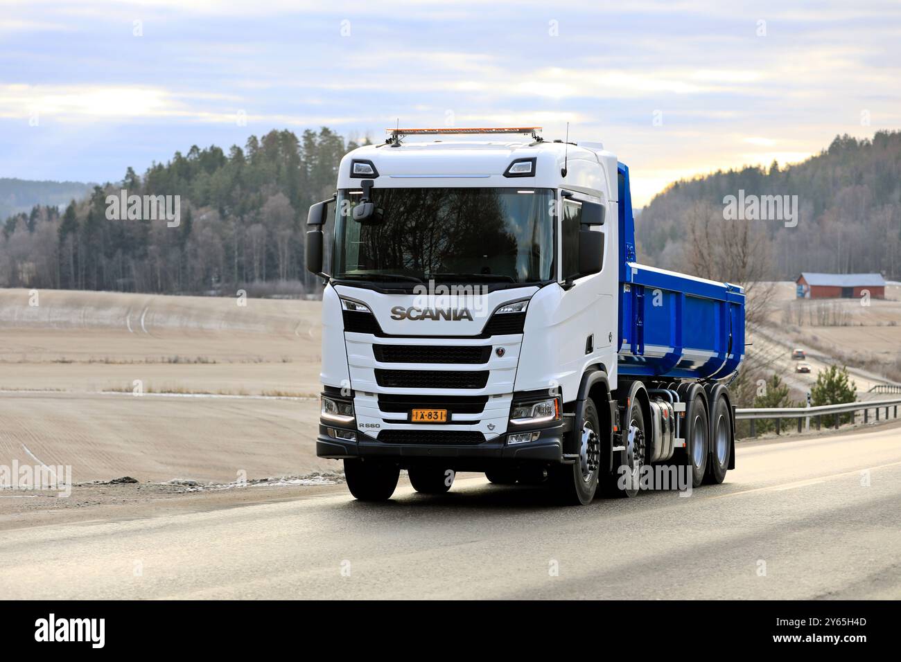 New, white Scania R660 tipper truck at speed in highway traffic on an ...