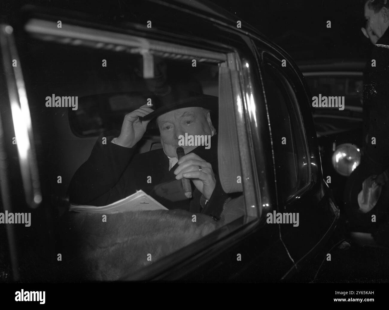 Churchill Back From Paris Talks Clutching a cigar in one hand and hat ...
