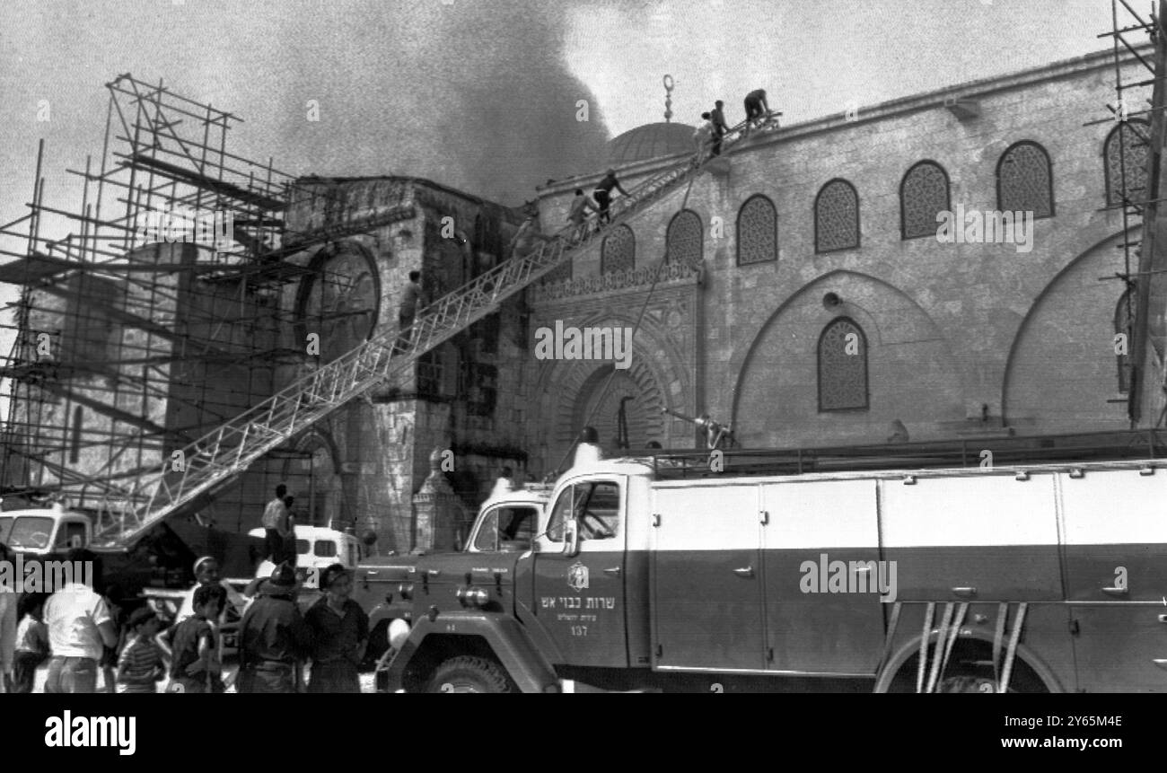 Firefighters scramble up an extension ladder to fight the blaze on the ...