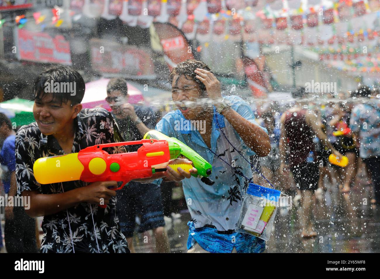 Bangkok, Thailand - April 13, 2023: People splash water using water guns during the celebration ...