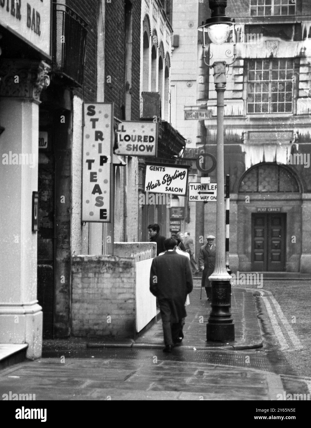A view of the entrance to an all coloured strip-tease club near Gerrard ...