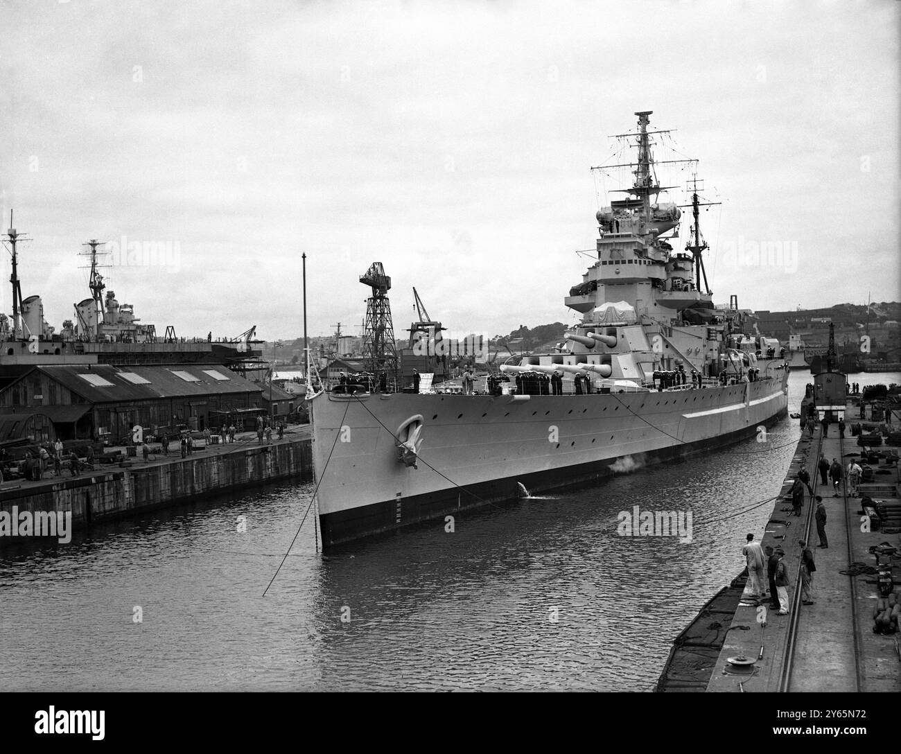 Edging slowly into dry dock at Devonport is the 35,000 ton King George ...