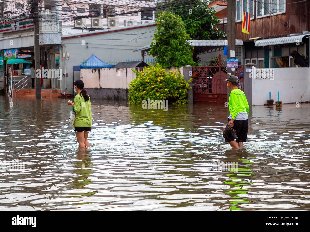 Chiang Mai, Thailand. 24th Sep, 2024. People wade through a flooded ...