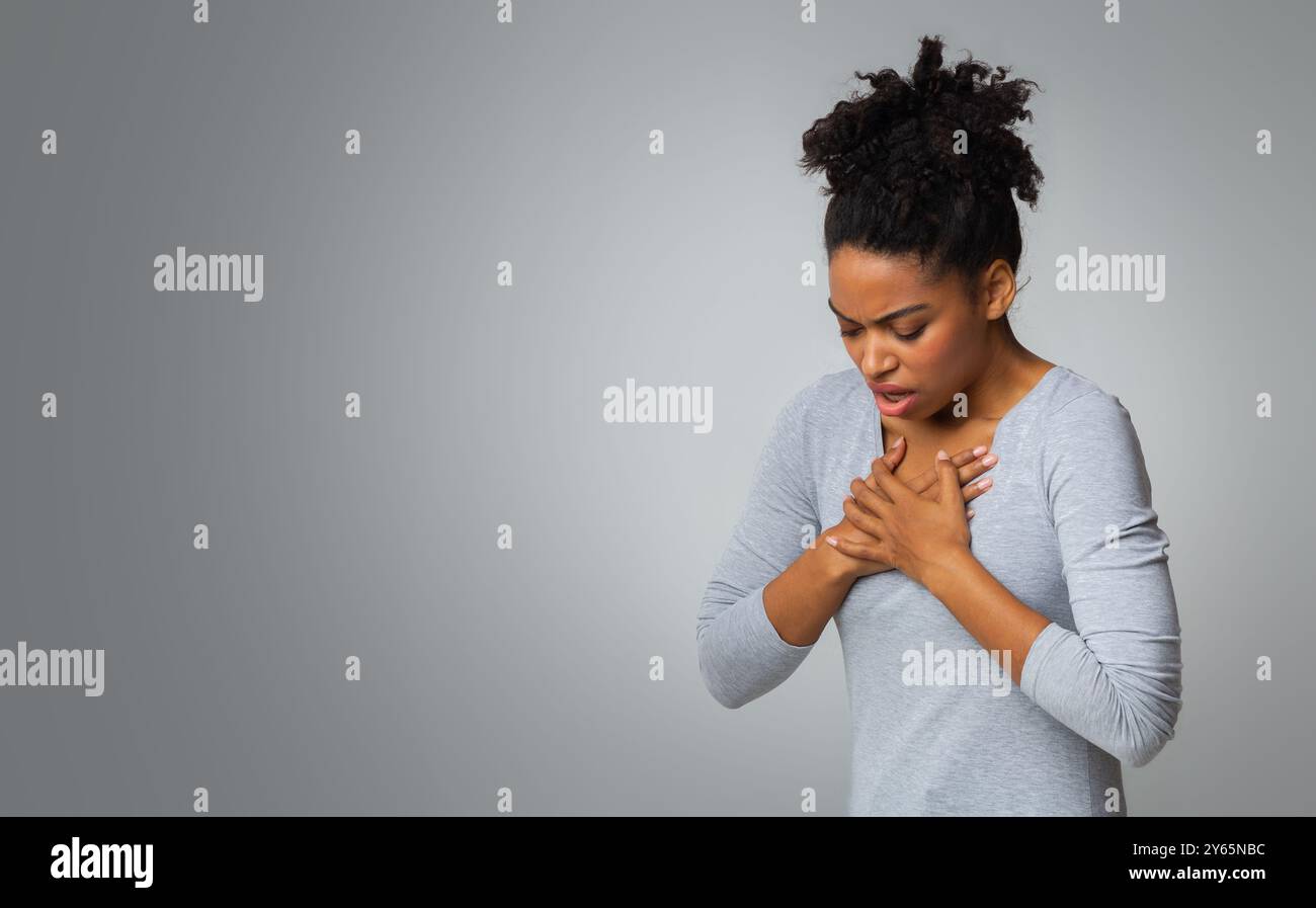 Sad young woman suffering from acute pain in chest Stock Photo - Alamy