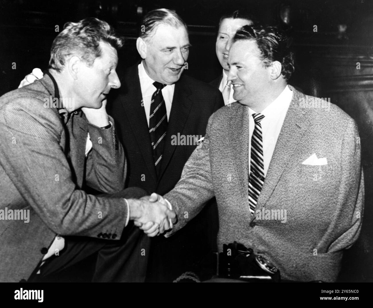 American comic , Danny Kaye ( left ) shakes hands with British radio ...