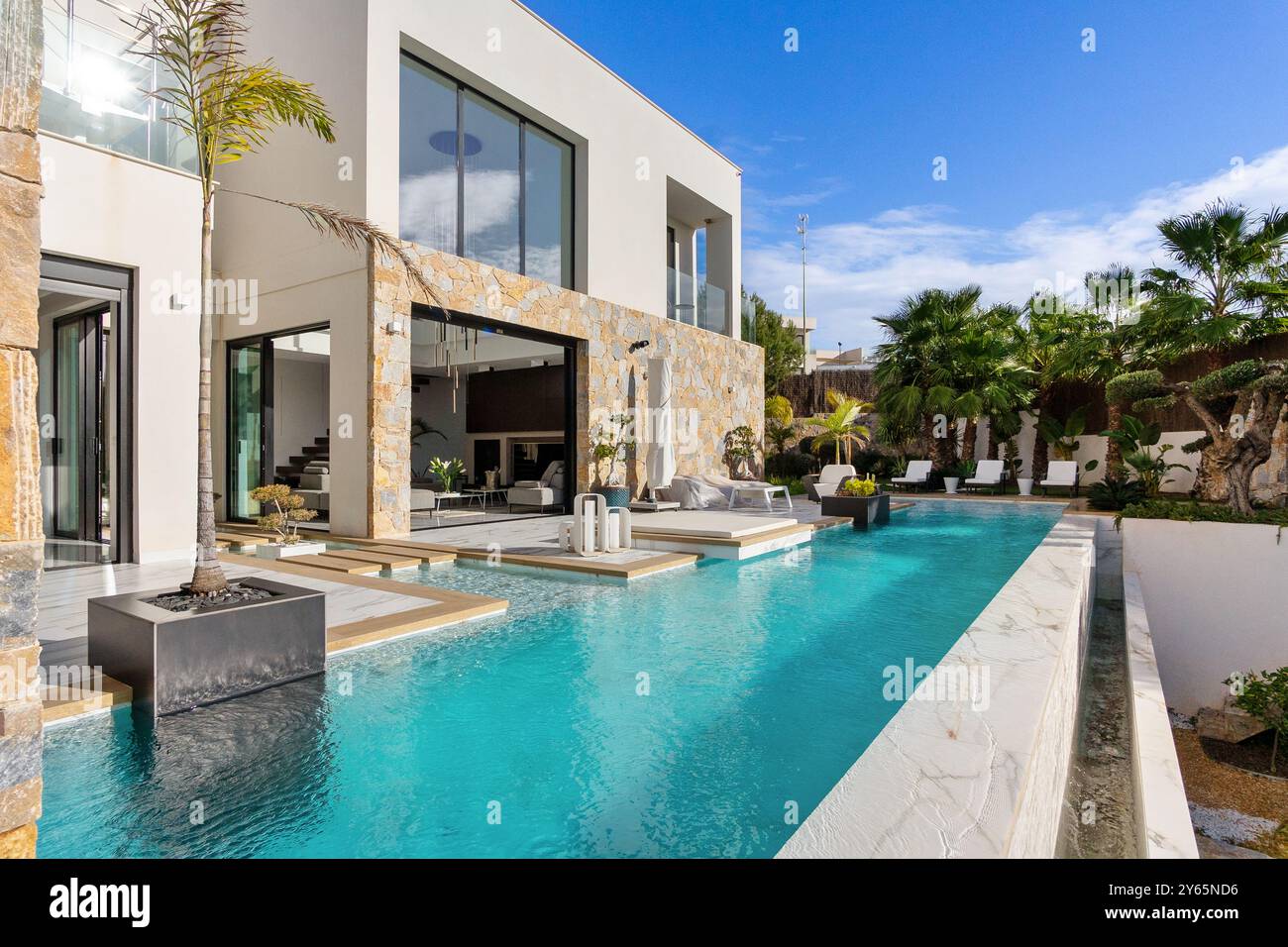 This elegant villa features a modern design with a spacious outdoor ...