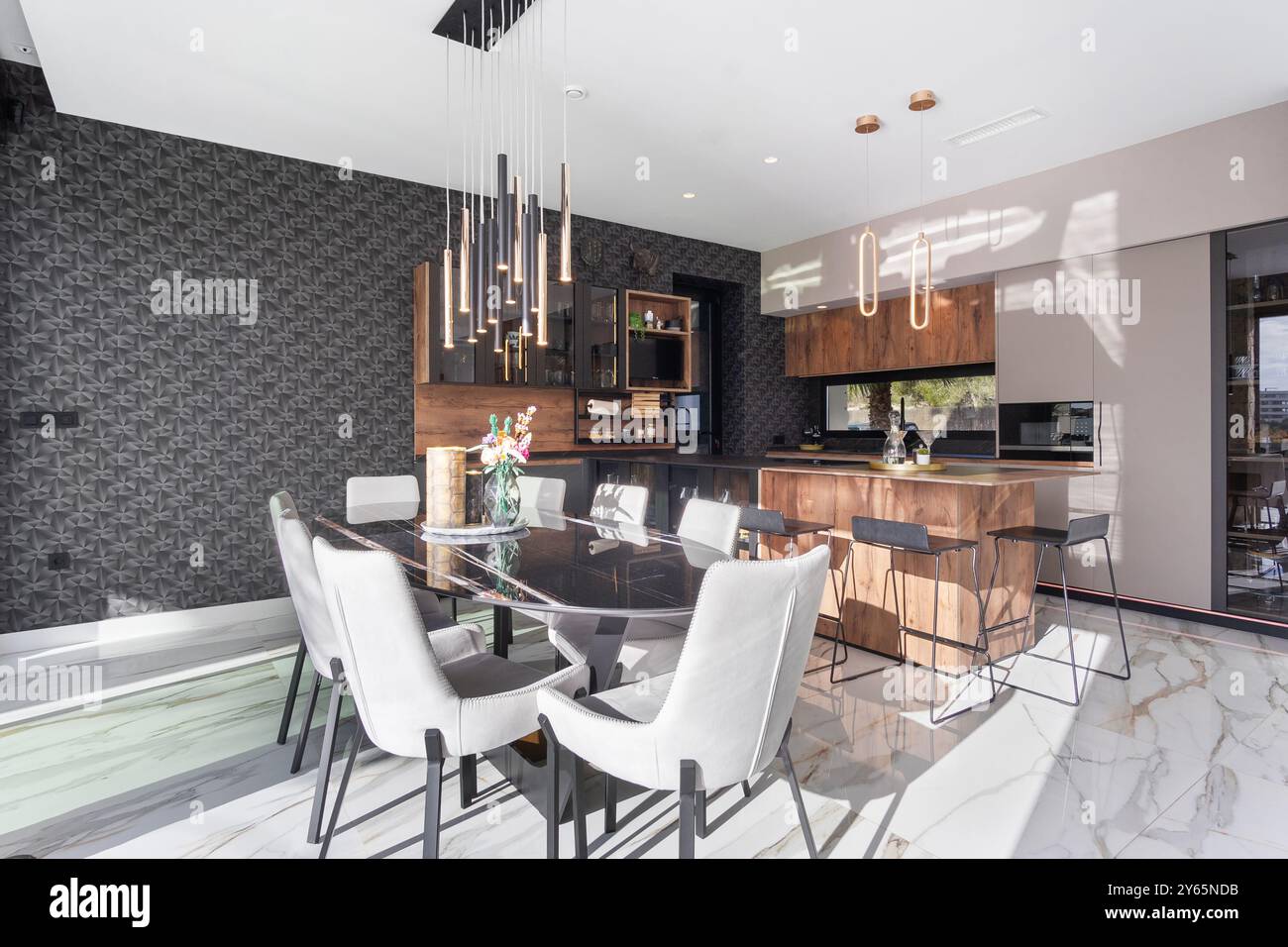 This image shows a contemporary and exclusive kitchen and dining space ...