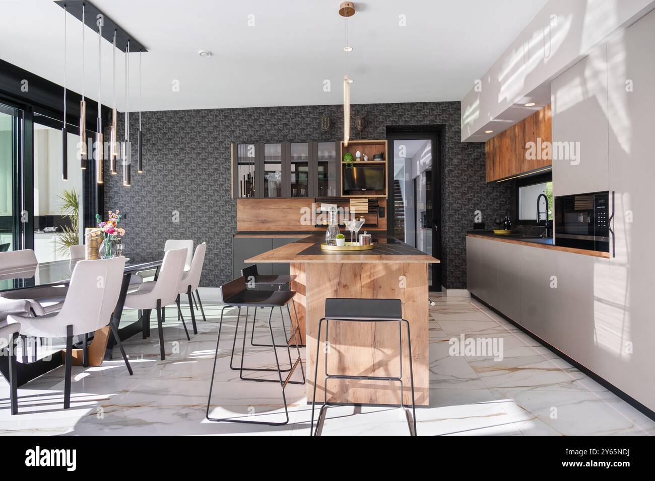 Luxurious modern kitchen features elegant seating, a stylish wooden ...