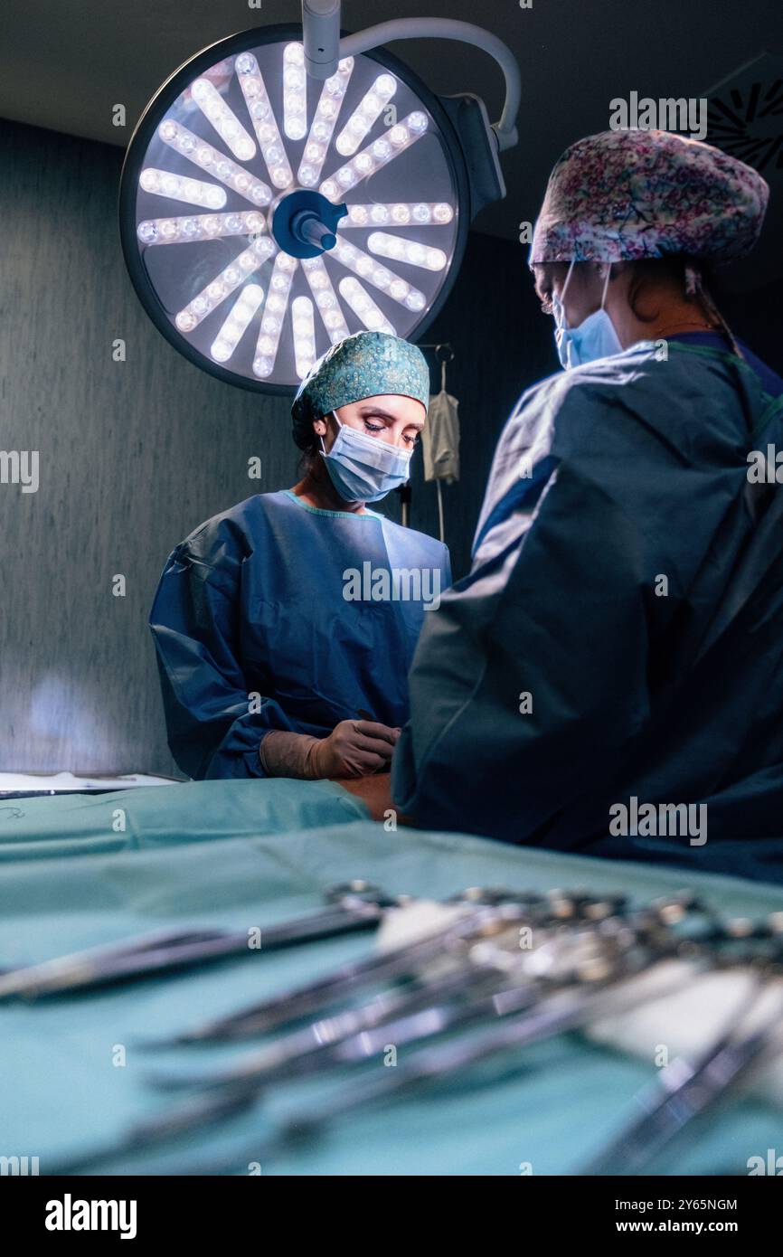 Surgical team focused during a procedure in a well-equipped operating ...