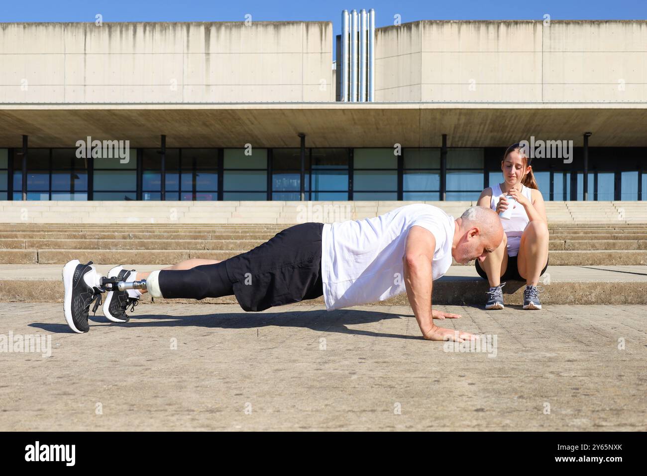 An inspiring image capturing a man with a prosthetic leg performing ...