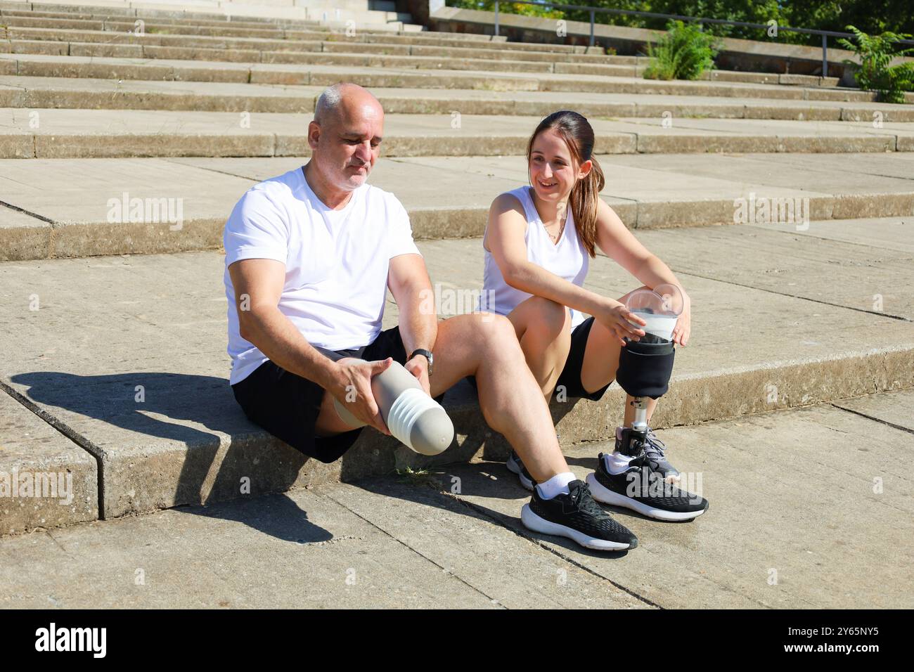 A middle-aged man with an amputated leg, wearing a modern prosthetic ...