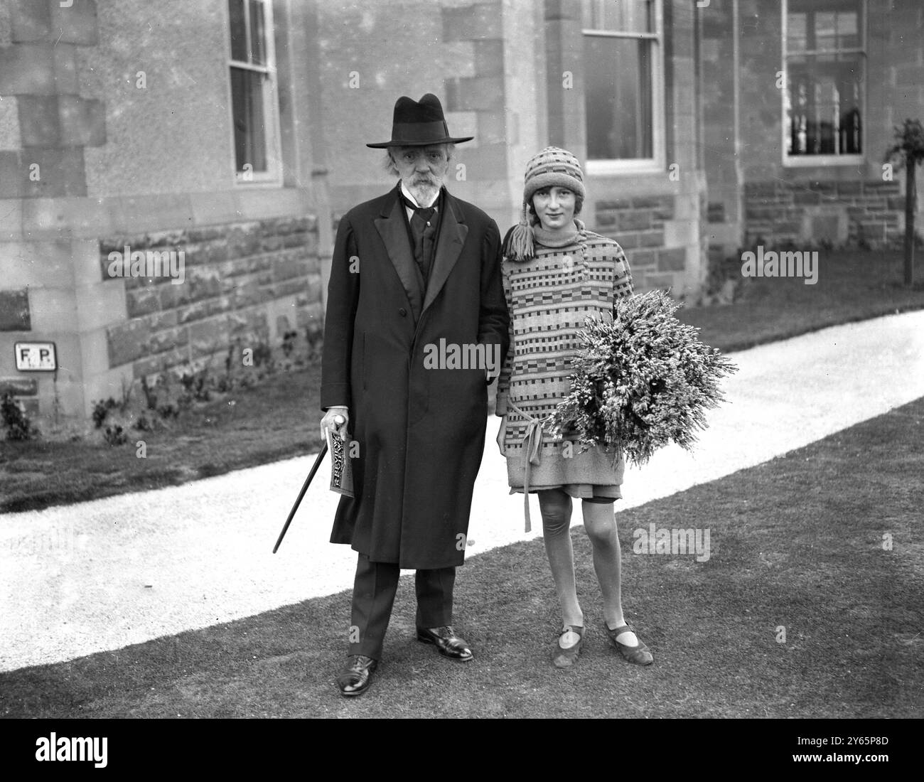 At the entrance to the Gleneagles Hotel , Sir Thomas Hall Caine with ...