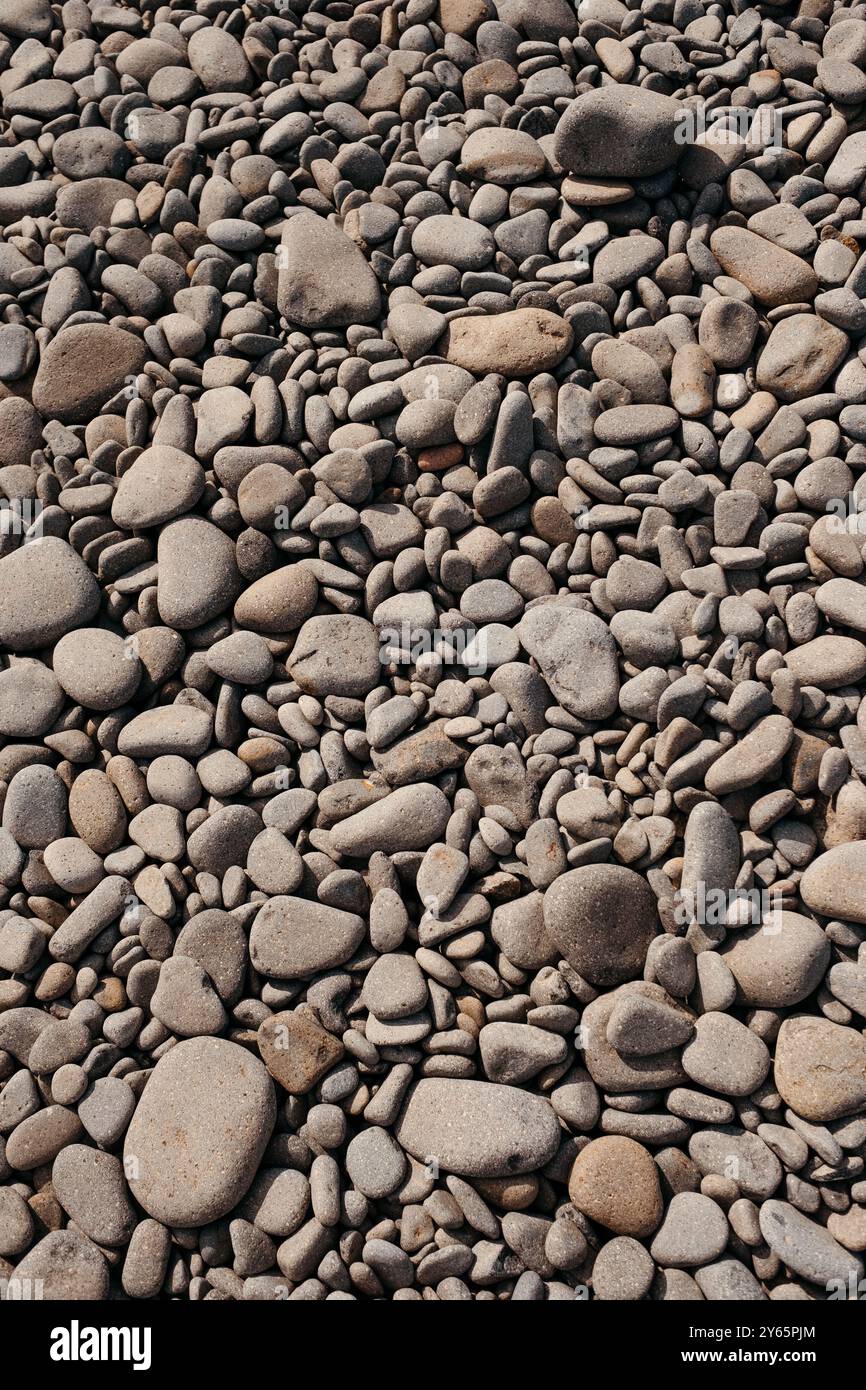 Detailed close-up of a myriad of smoothly rounded pebble stones ...